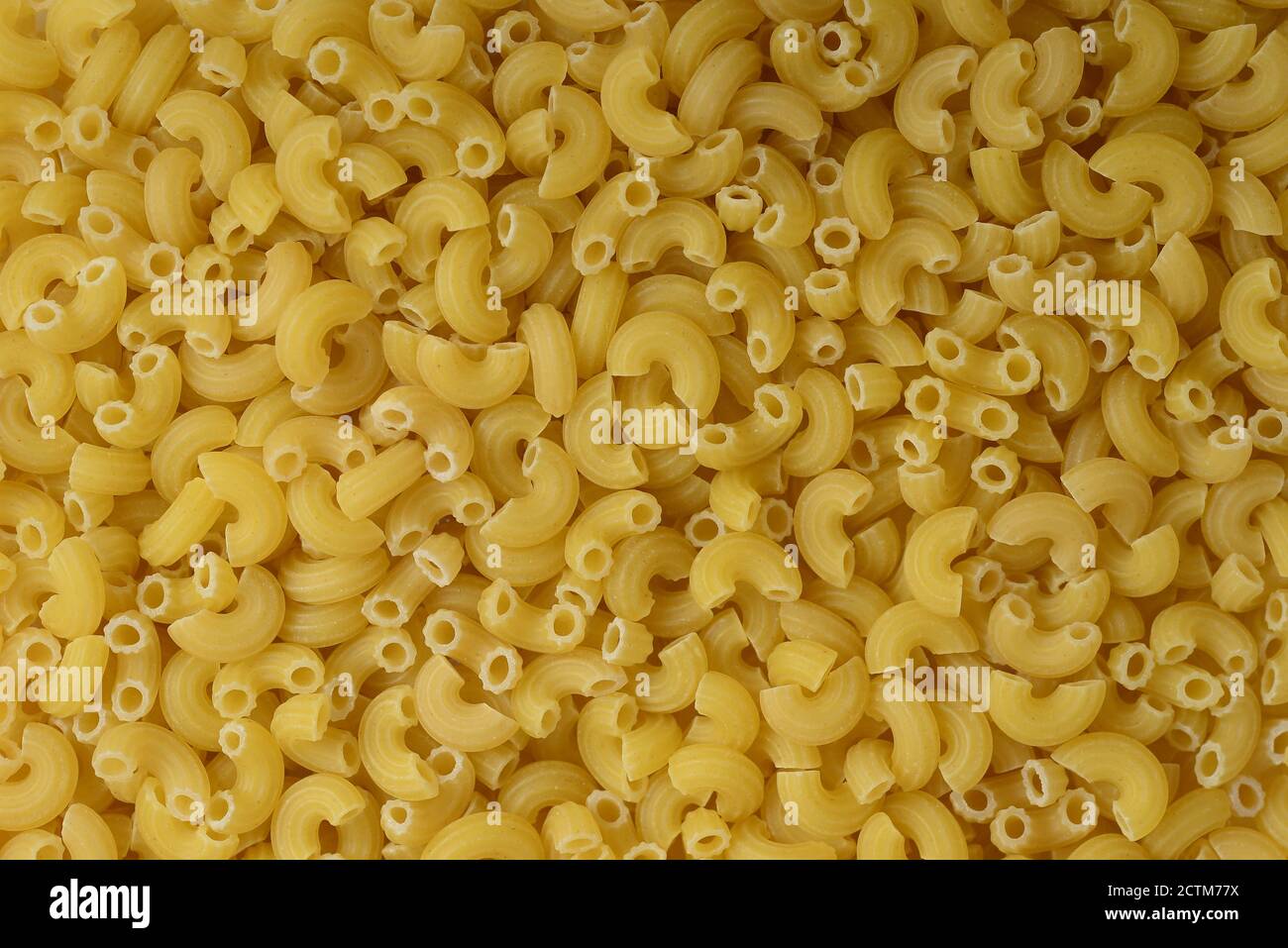 Elbow Macaroni Background, close up of italian macaroni pasta food ...