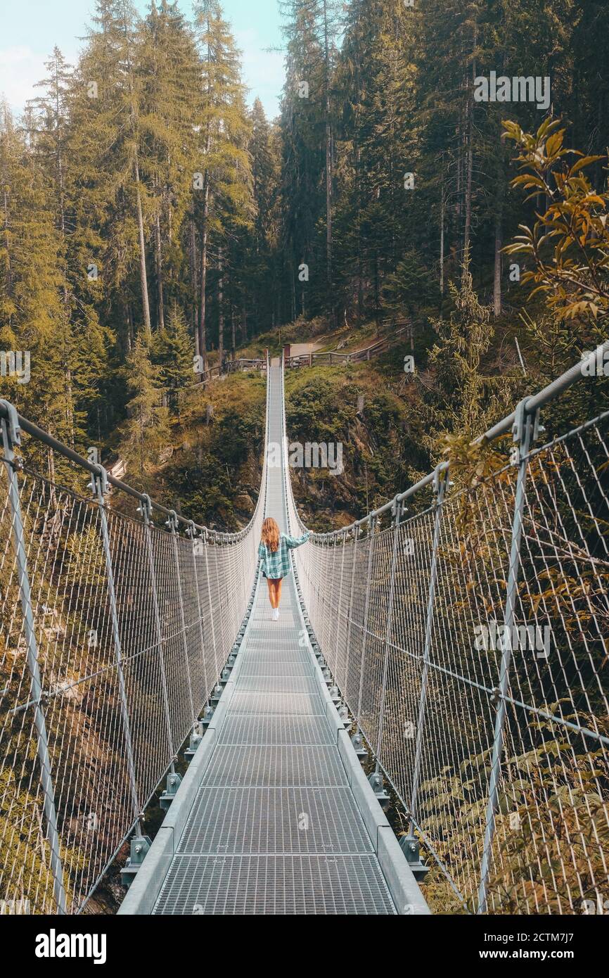 Person on a self-anchored suspension bridge Stock Photo - Alamy