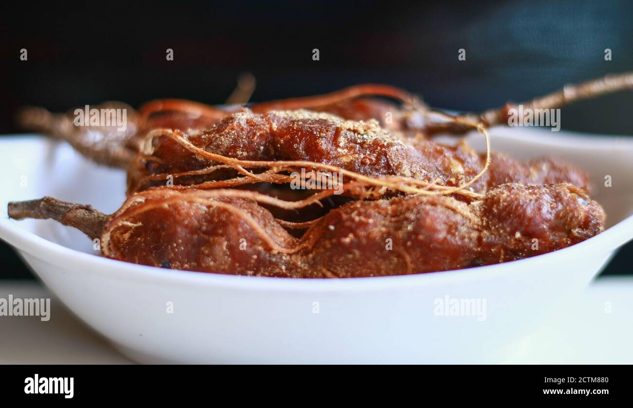 Tamarind or Tamarindus indica on wood background Stock Photo - Alamy