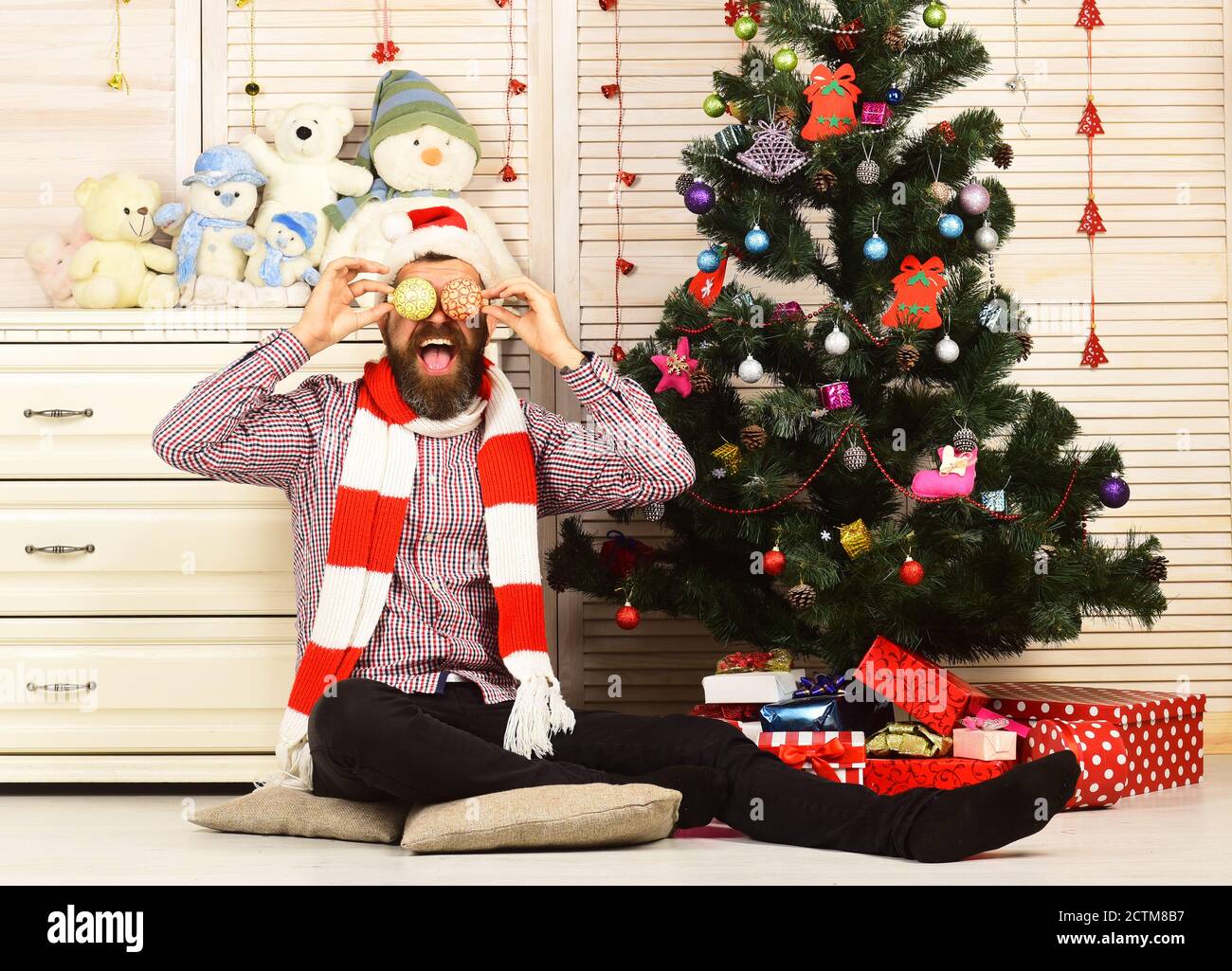Festivals and decor concept. Man with beard holds golden Christmas ...
