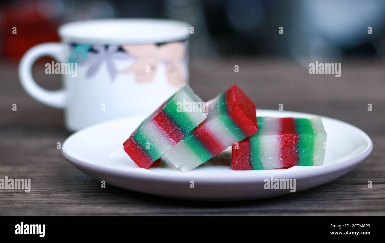 Rice Flour Layer Cake and a cup of drink on wood background. Indonesian ...