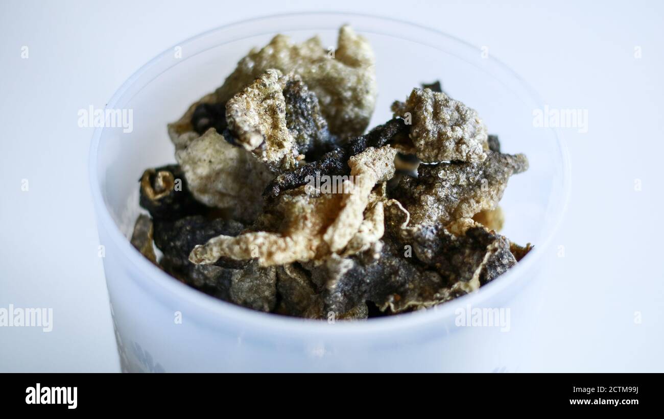 Fish skin crackers on white background. Made from patin fish Stock ...