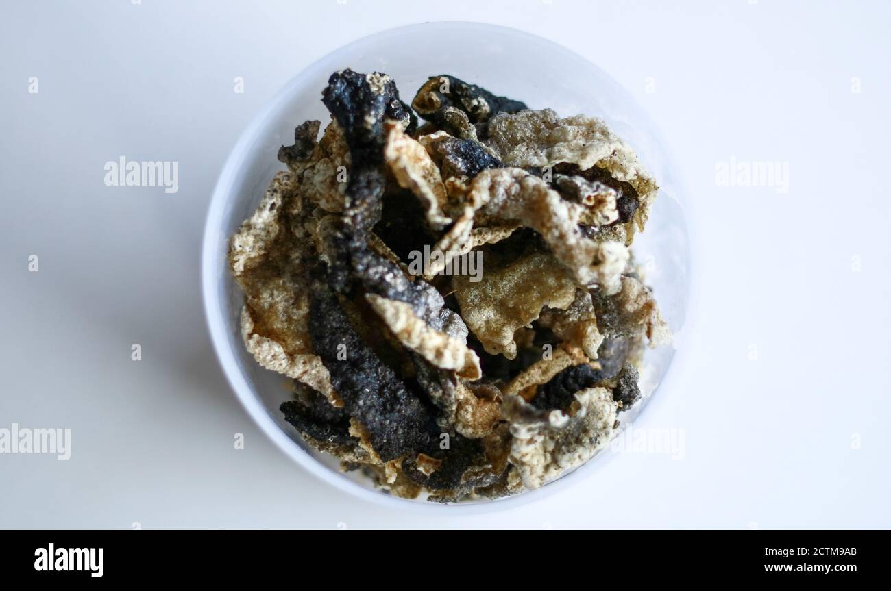 Fish skin crackers on white background. Made from patin fish Stock ...