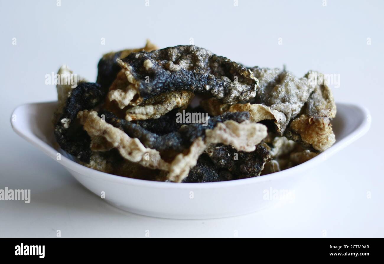 Fish skin crackers on white background. Made from patin fish Stock ...
