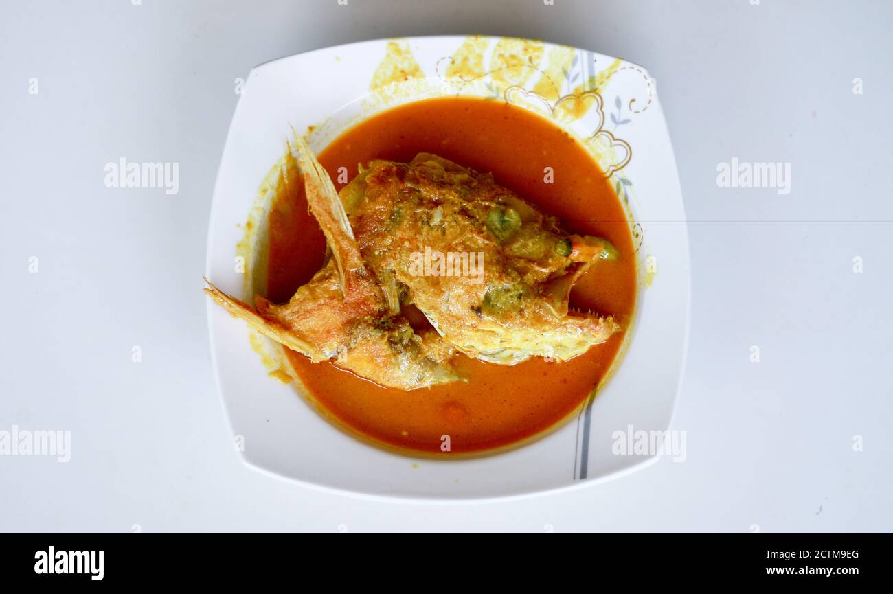 Snapper head gulai (curry) on white background. Gulai is type of food ...