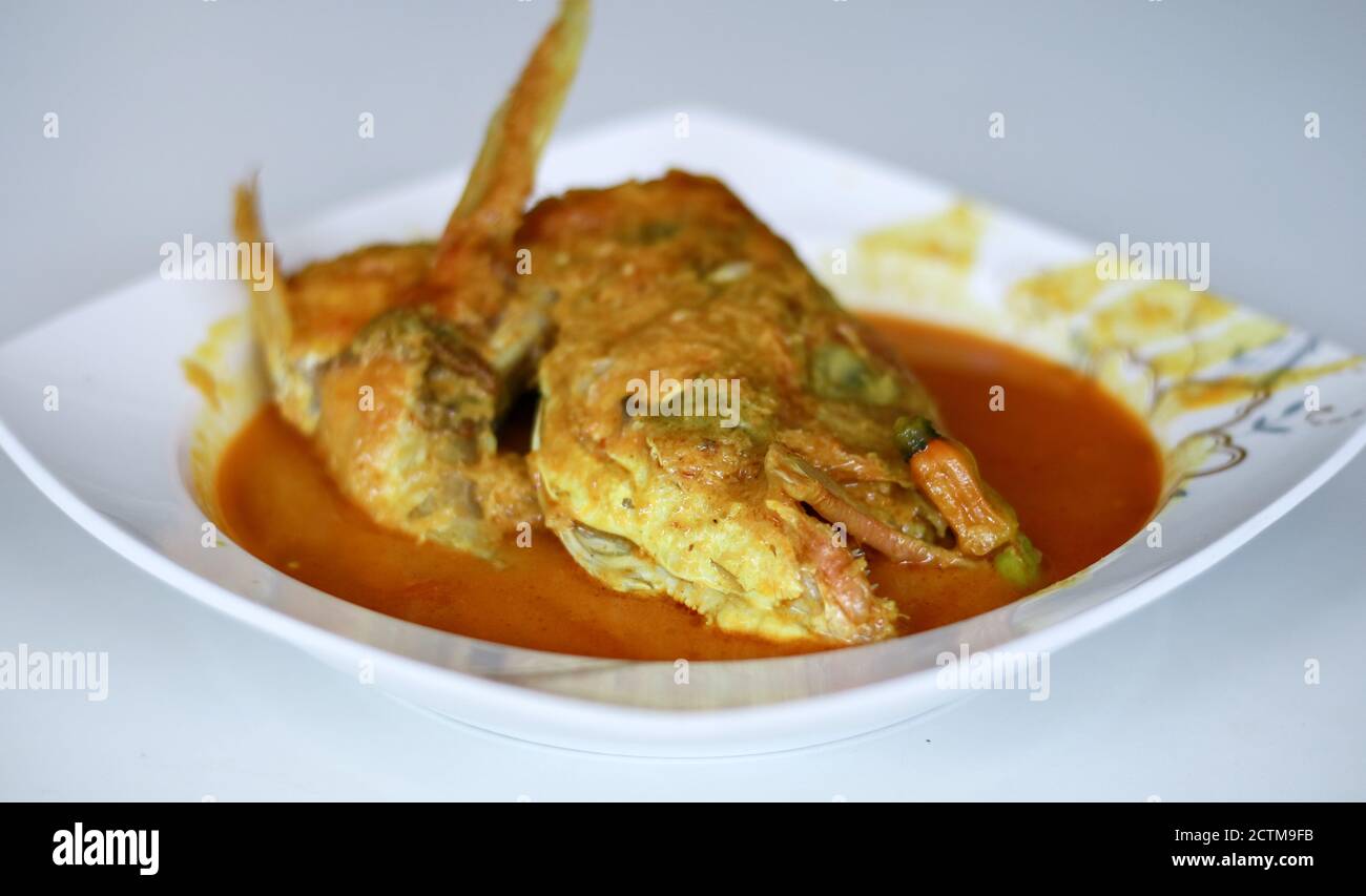 Snapper head gulai (curry) on white background. Gulai is type of food ...