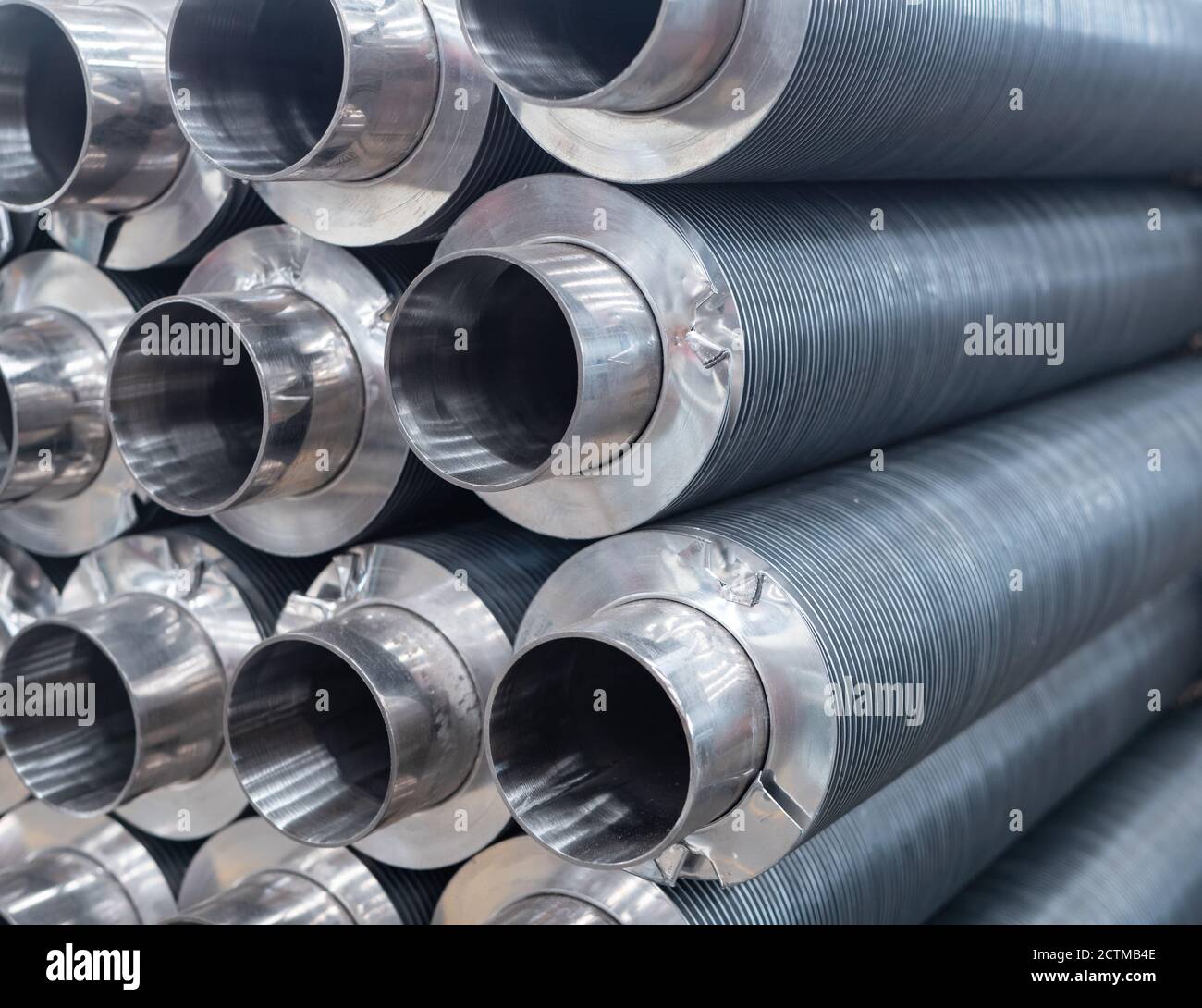 Stacked stainless steel tubes with cooling ribs Stock Photo - Alamy