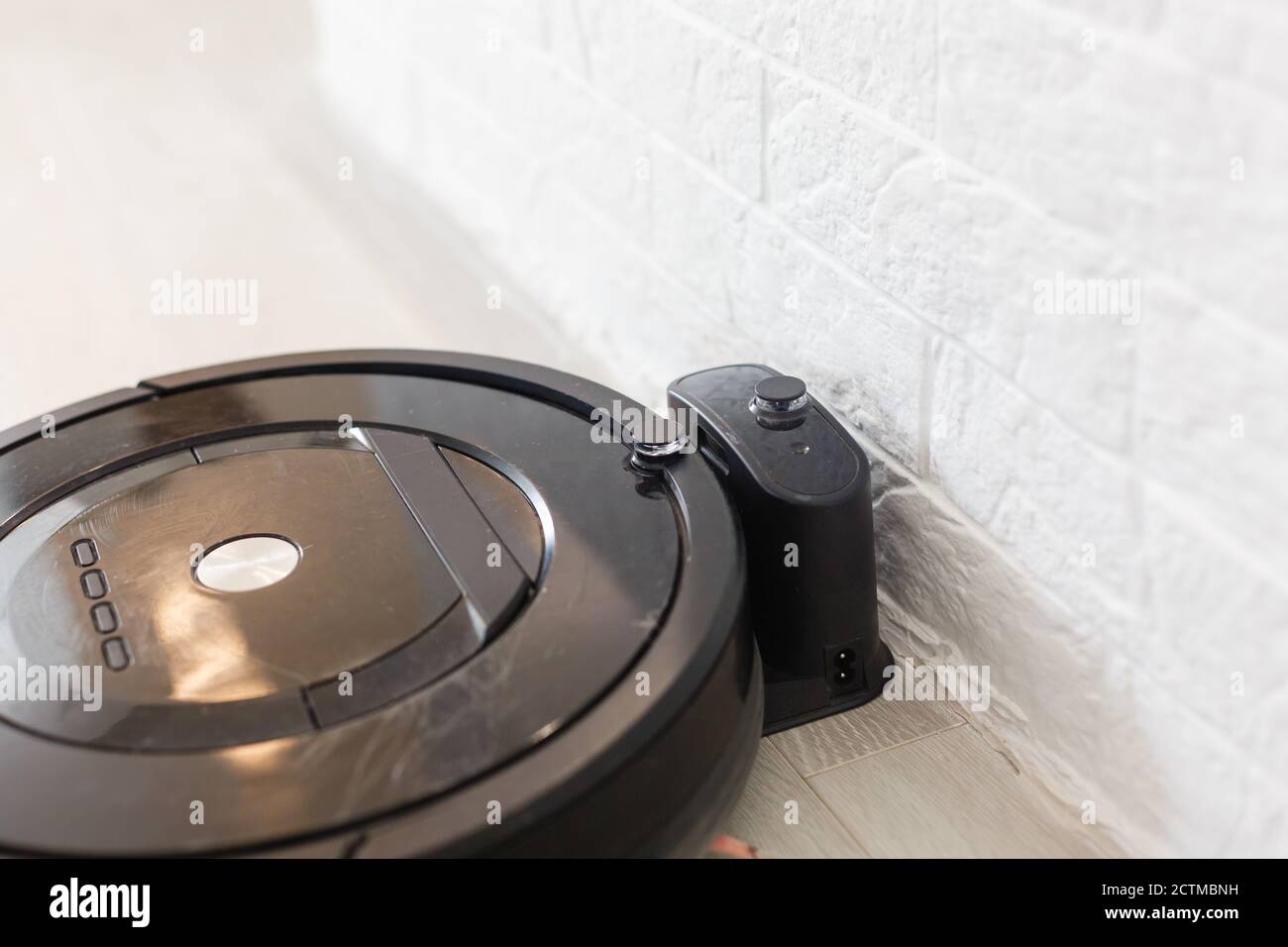 robotic vacuum cleaner charging battery at charging dock Stock Photo ...