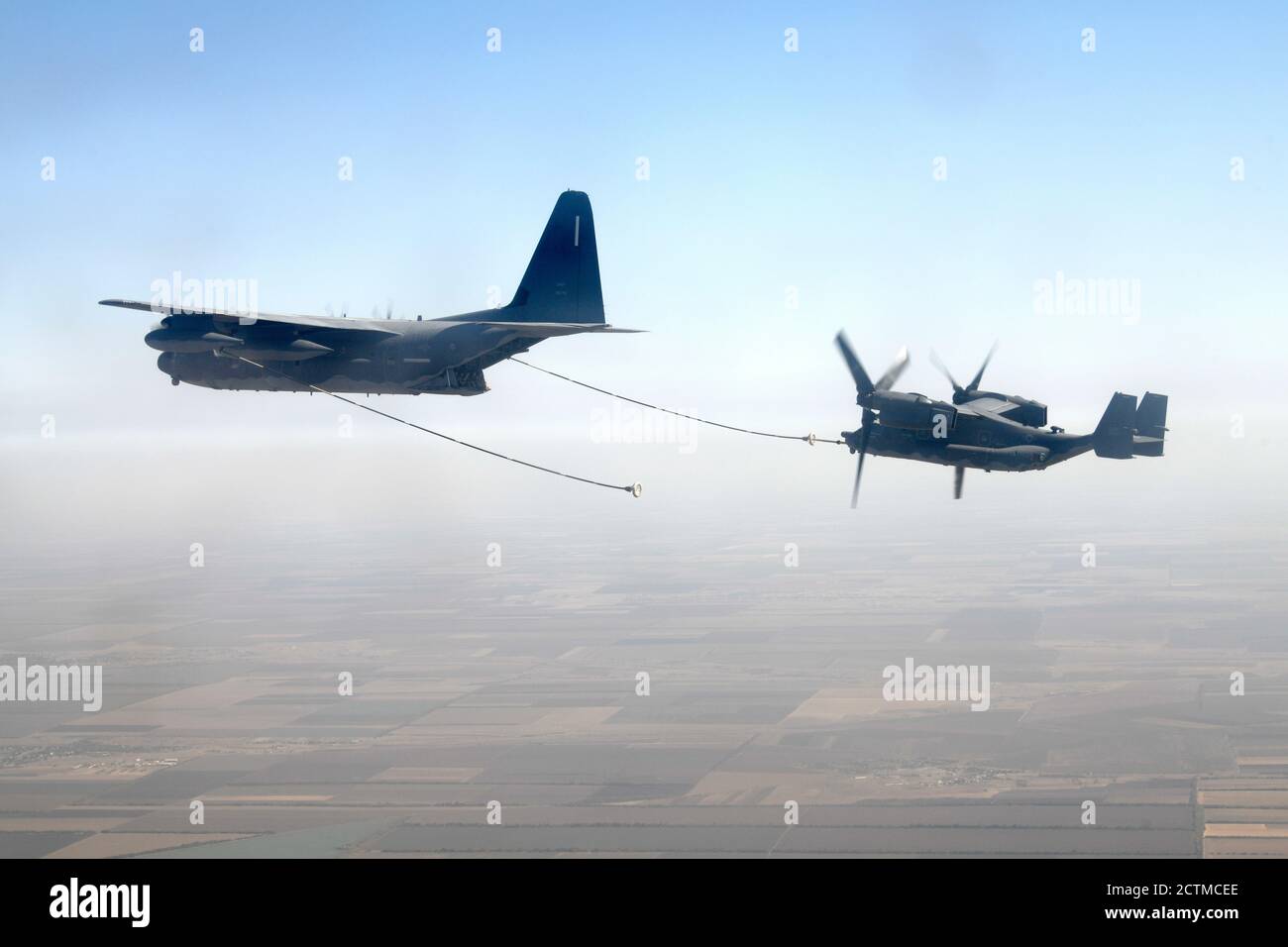 A U.S. Air Force MC-130J Commando II conducts tilt rotor air-to-air ...