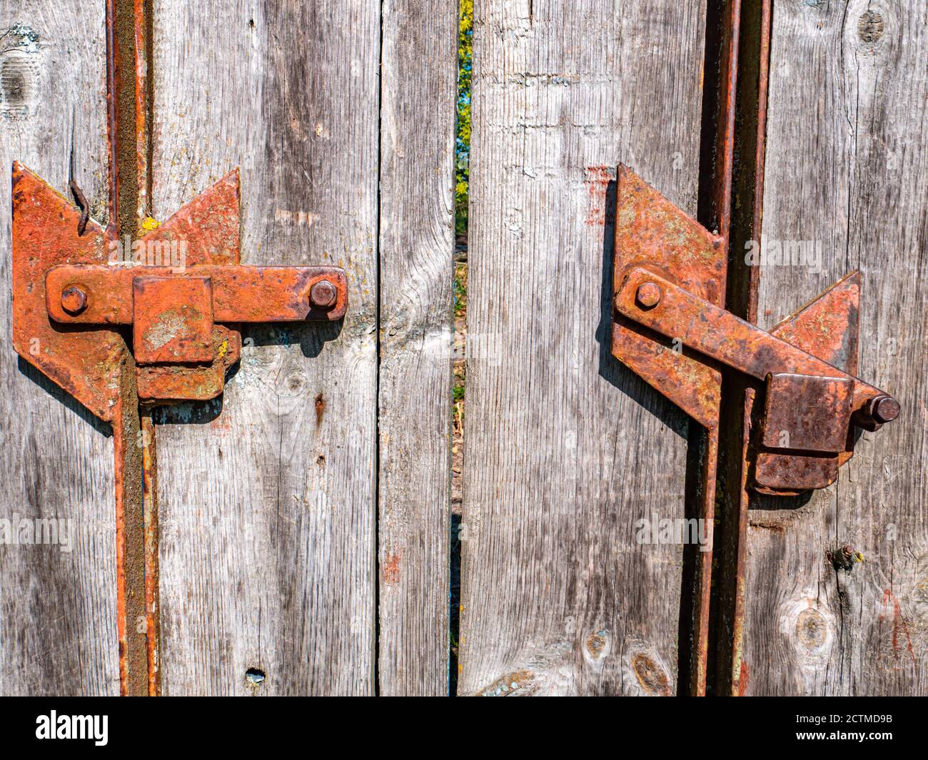 Old rusty iron bolt of a wooden gate lock Stock Photo - Alamy