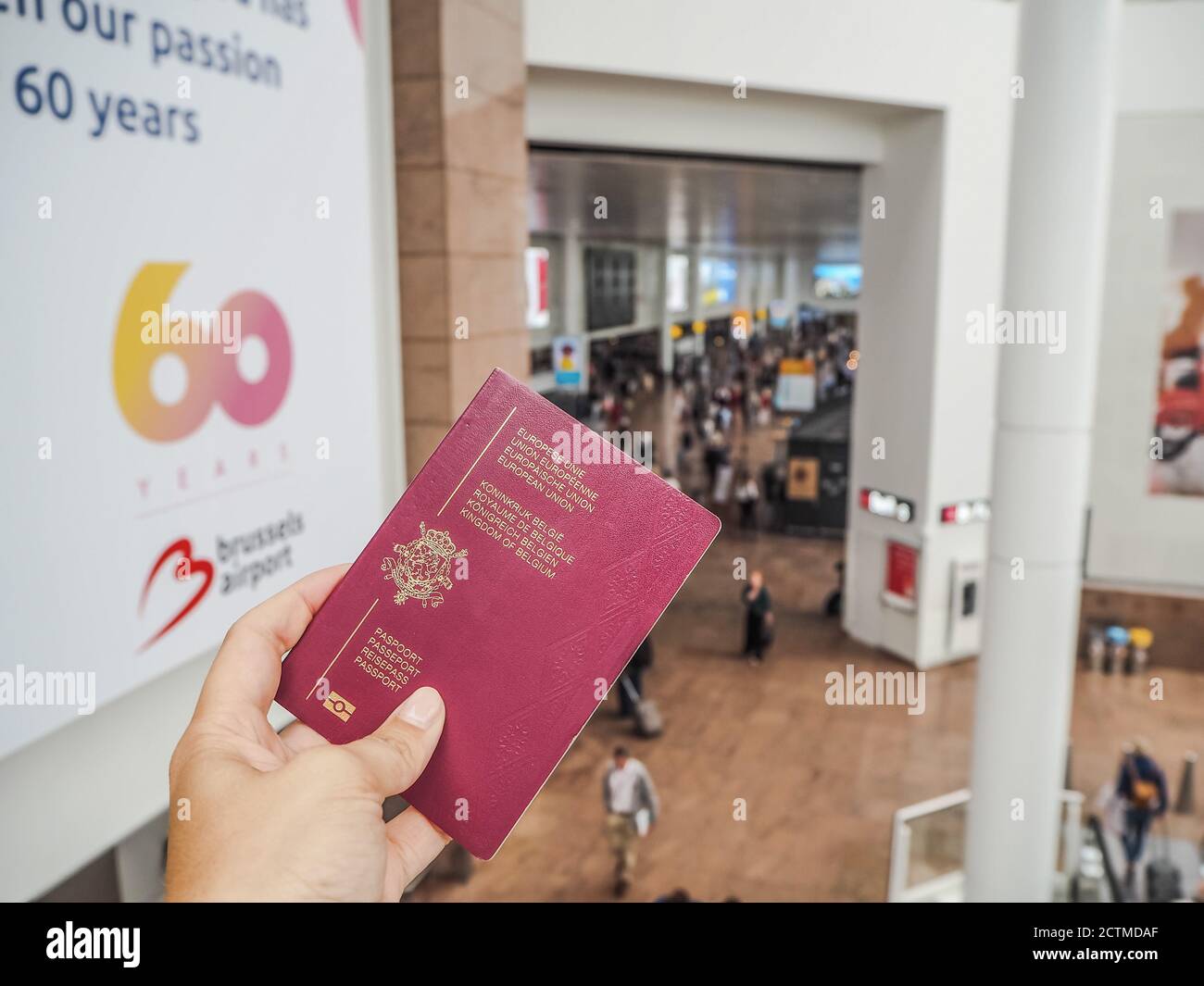 August 2018 - Zaventem, Belgium: Hand holding a Belgian passport at the ...