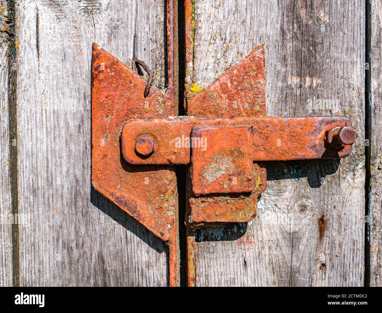 Old rusty iron bolt of a wooden gate lock Stock Photo - Alamy
