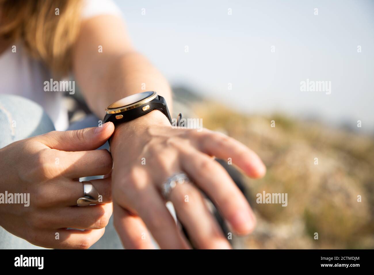 Young woman wearing smartwatch using hi-res stock photography and ...