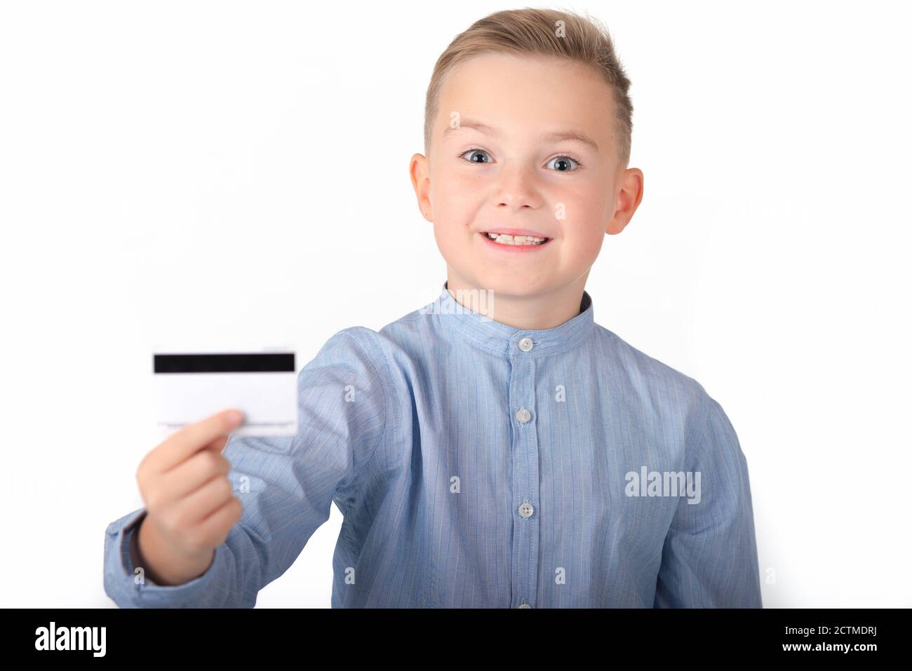 blonde caucasian cute young boy in blue shirt holding credit card ...