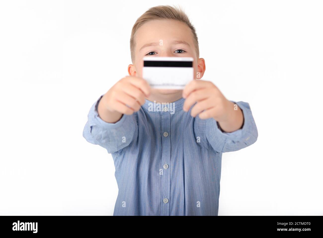 blonde caucasian cute young boy in blue shirt holding credit card ...