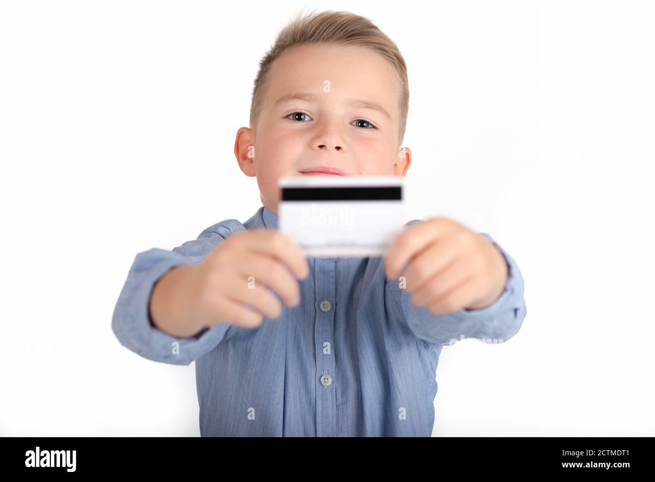 blonde caucasian cute young boy in blue shirt holding credit card ...