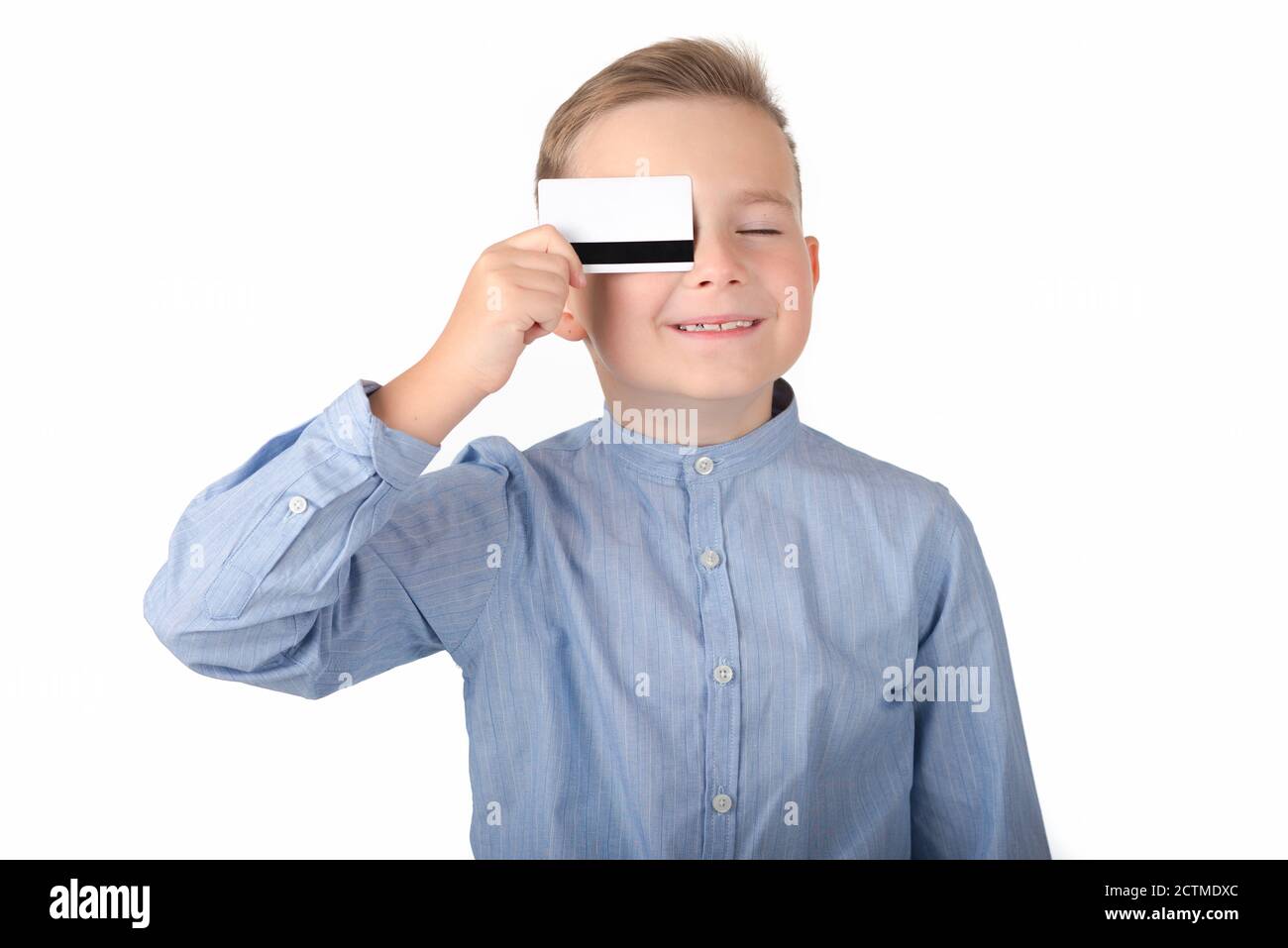 Young european happy boy holding credit card.Boy is closed eyes on the ...