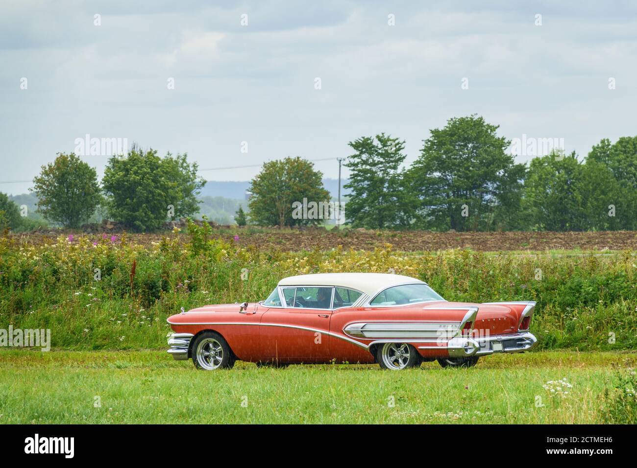 Beautiful old American vintage car driving in the countryside Stock ...