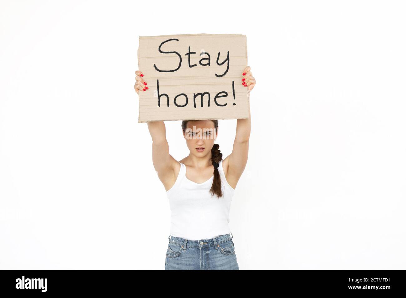 Stay home. Young woman protesting with sign isolated on white studio ...