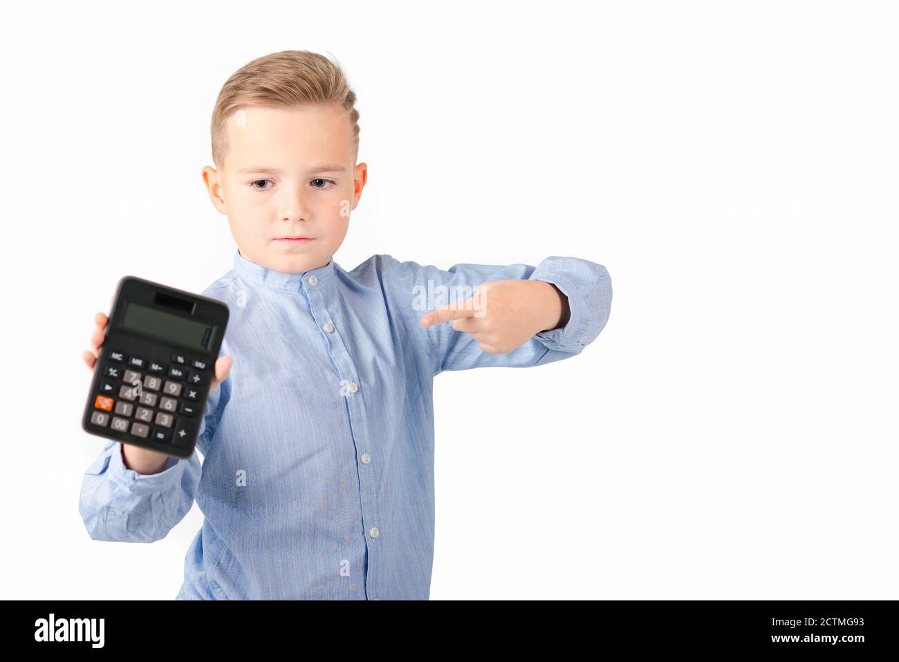 Schoolboy shows calculator. Portrait of funny cute 10s boy . tired ...