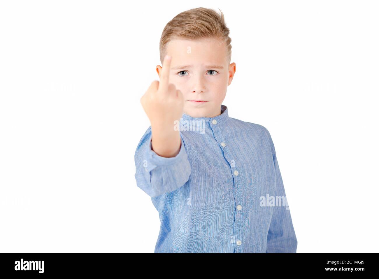 School boy shows rude gesture on a white studio background Stock Photo ...