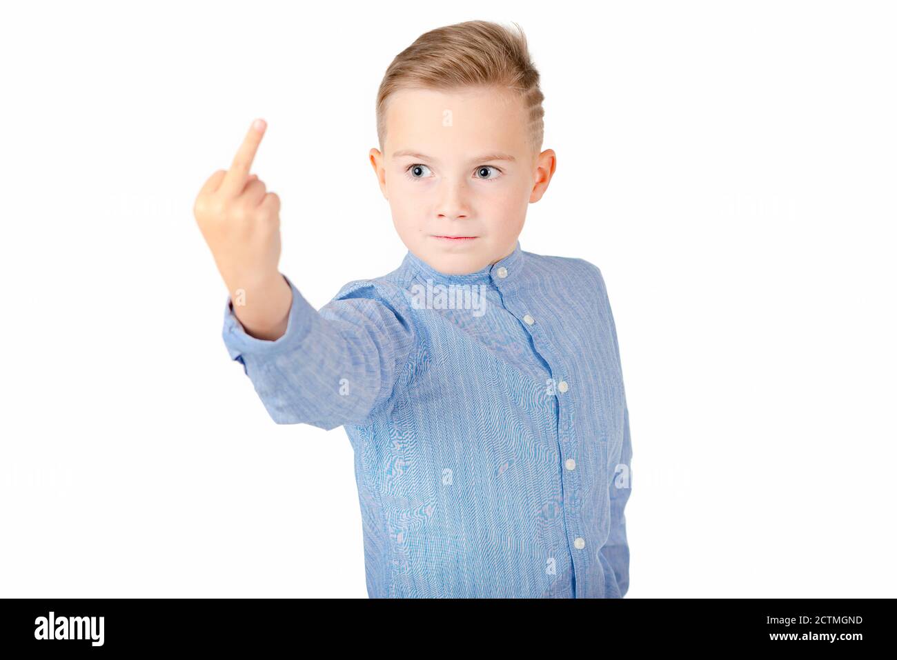 School boy shows rude gesture on a white studio background Stock Photo ...