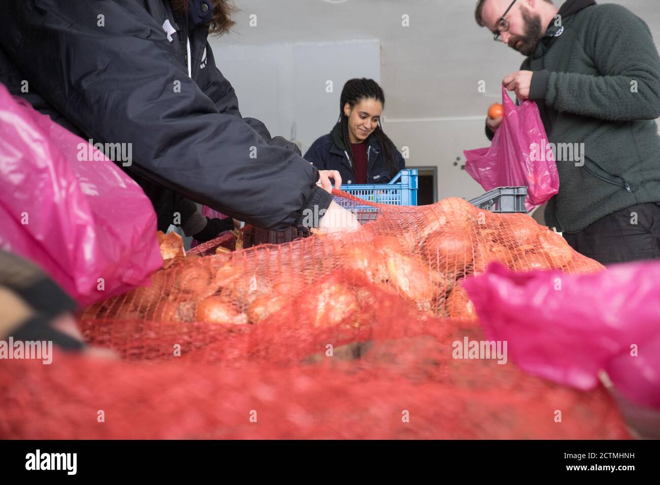 Volunteers organise food distribution in a charity warehouse in ...