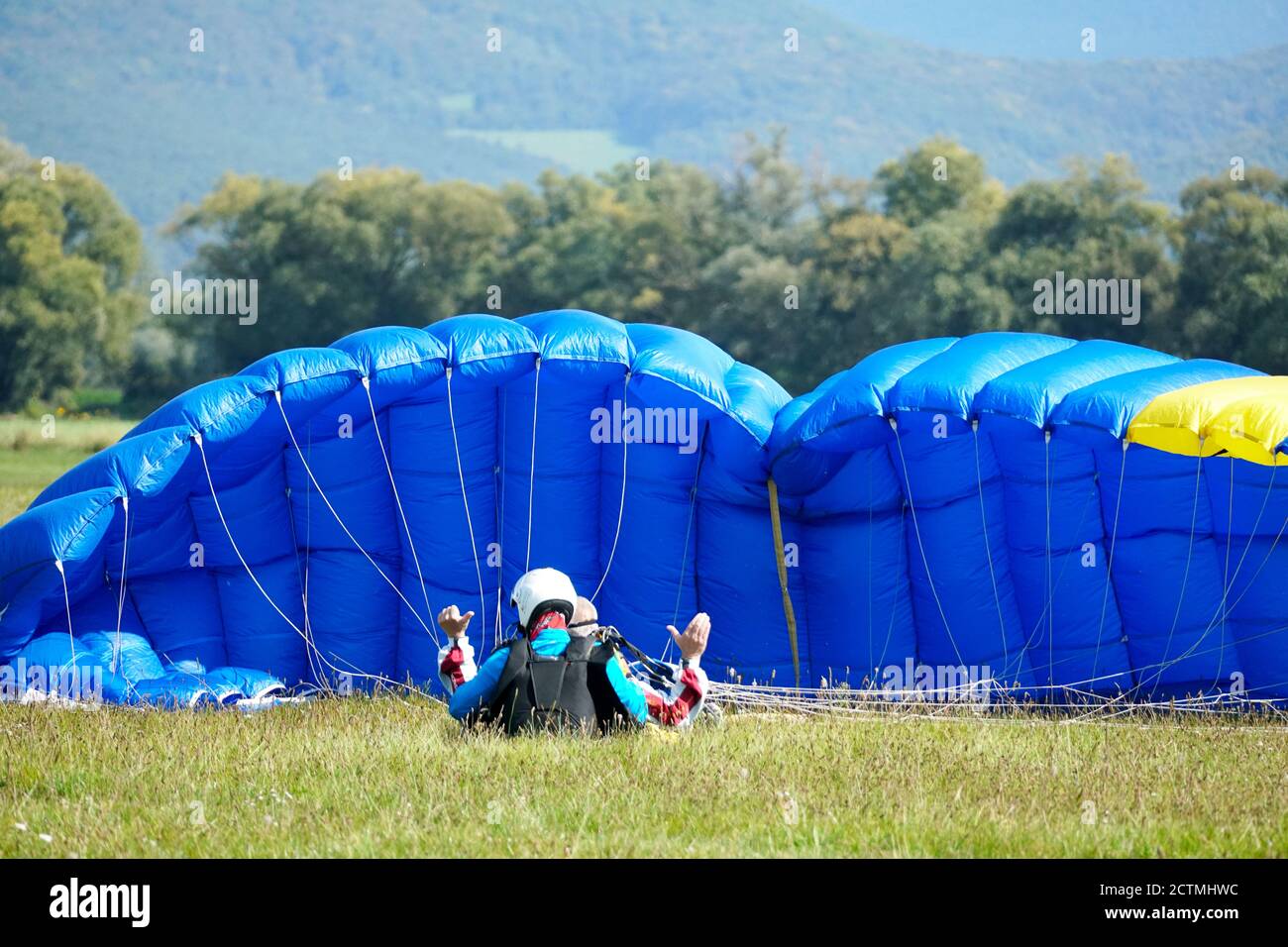 Tandem parachute jump shortly after the moment of landing colourful ...