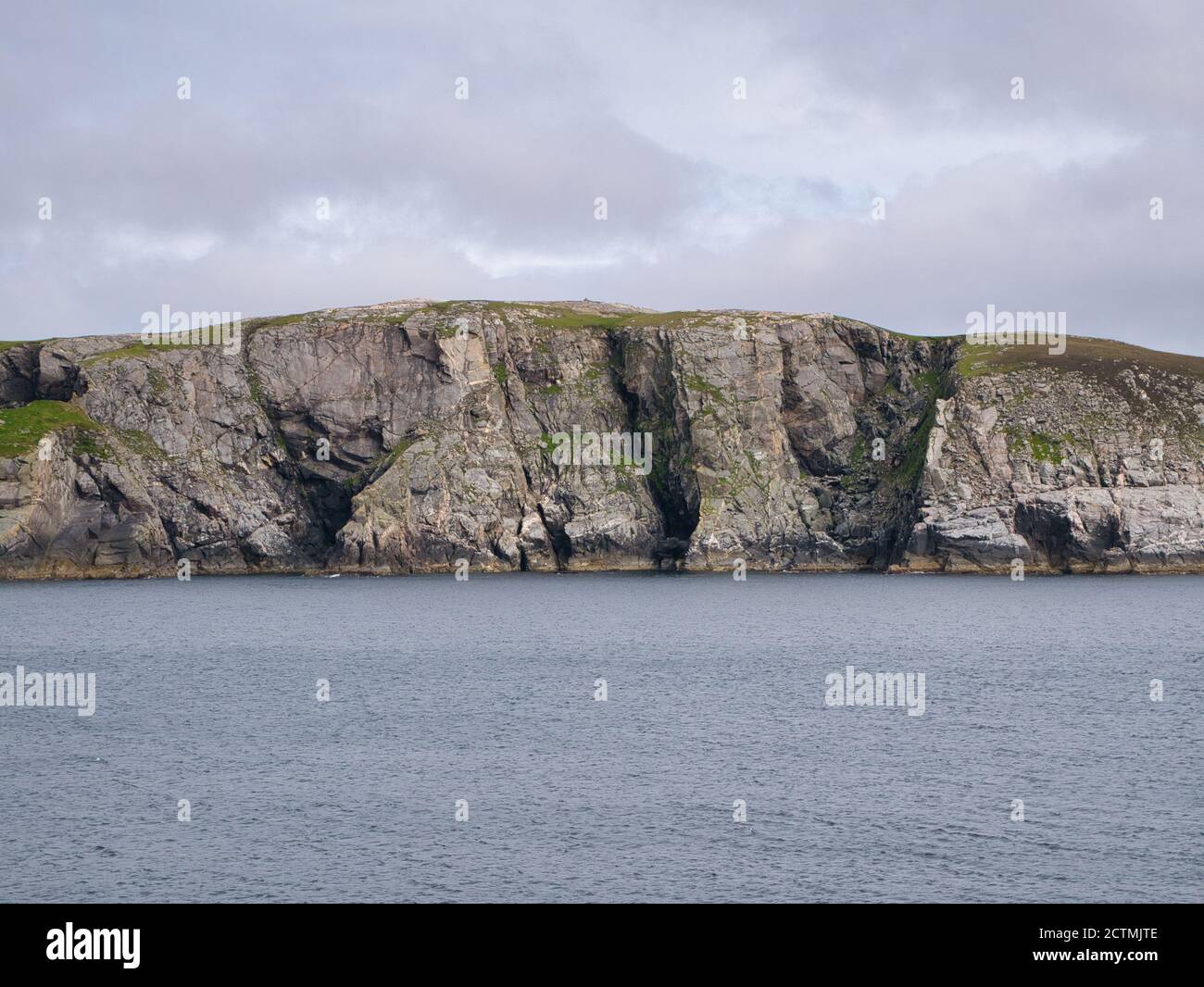 Sea cliffs showing rock strata on Whale Firth at the Lee of Vollister ...