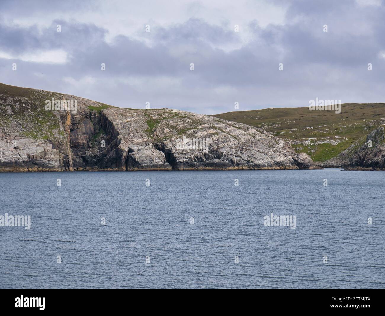 Sea cliffs showing rock strata on Whale Firth at the Lee of Vollister ...