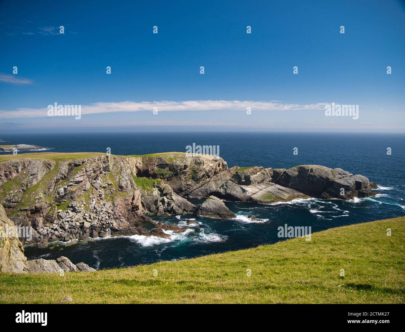 Steeply inclined eroded rock strata on Funzie Ness on the island of ...