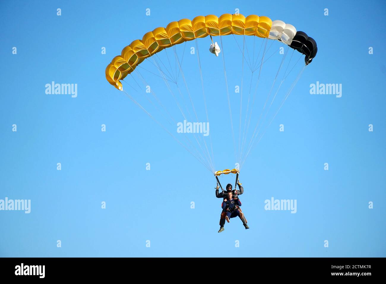 Tandem parachute jump shortly before the moment of landing colourful ...