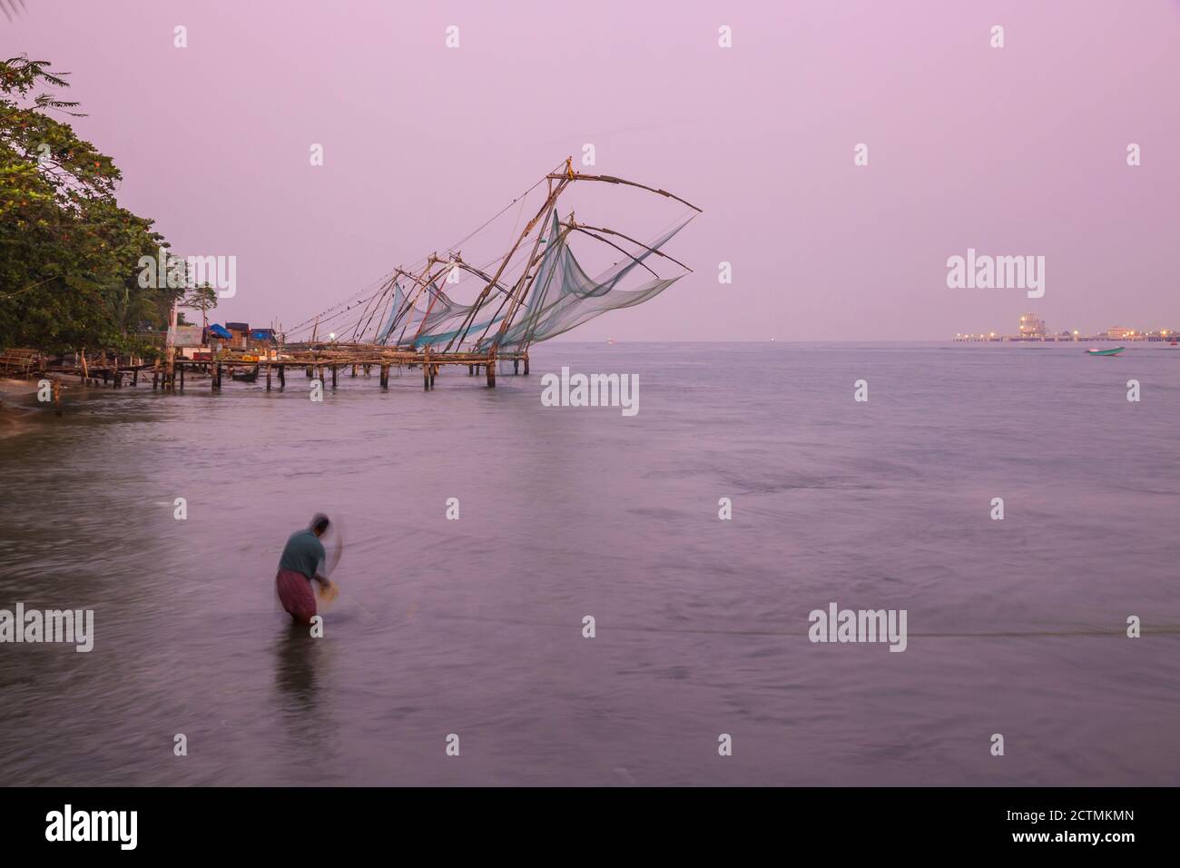 India, Kerala, Cochin - Kochi, Fort Kochi, Man fishing infront of ...