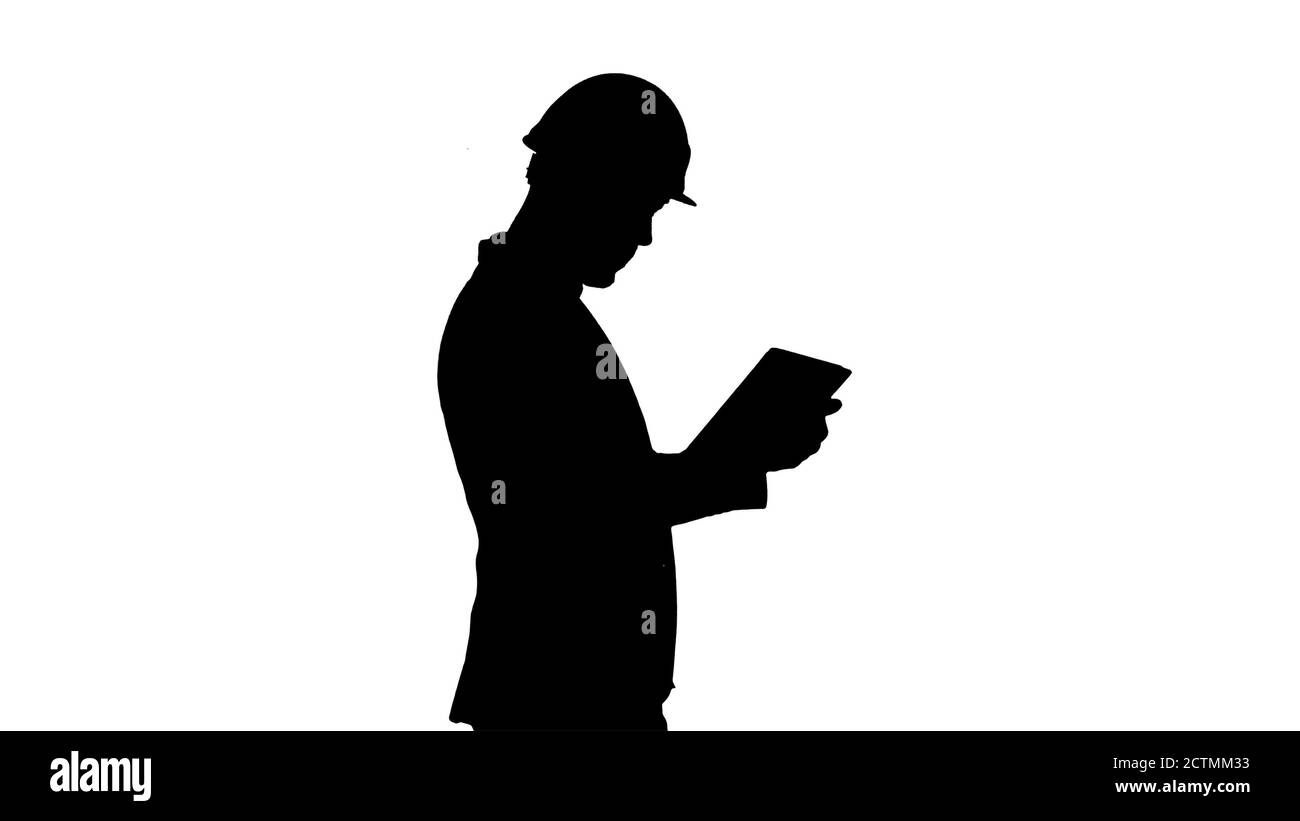 Silhouette Engineer walking and working on digital tablet Stock Photo ...