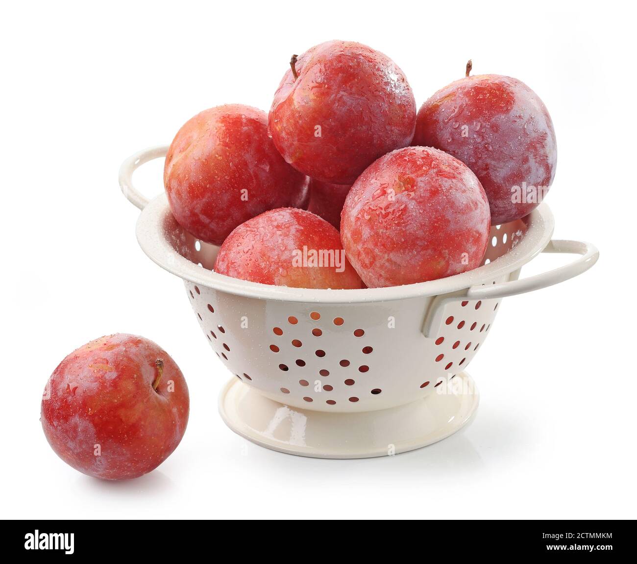 ripe red wet plums in colander isolated on white background Stock Photo ...