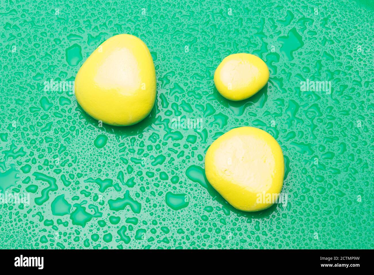 Color stones on a green background; various colors, yellow, black ...