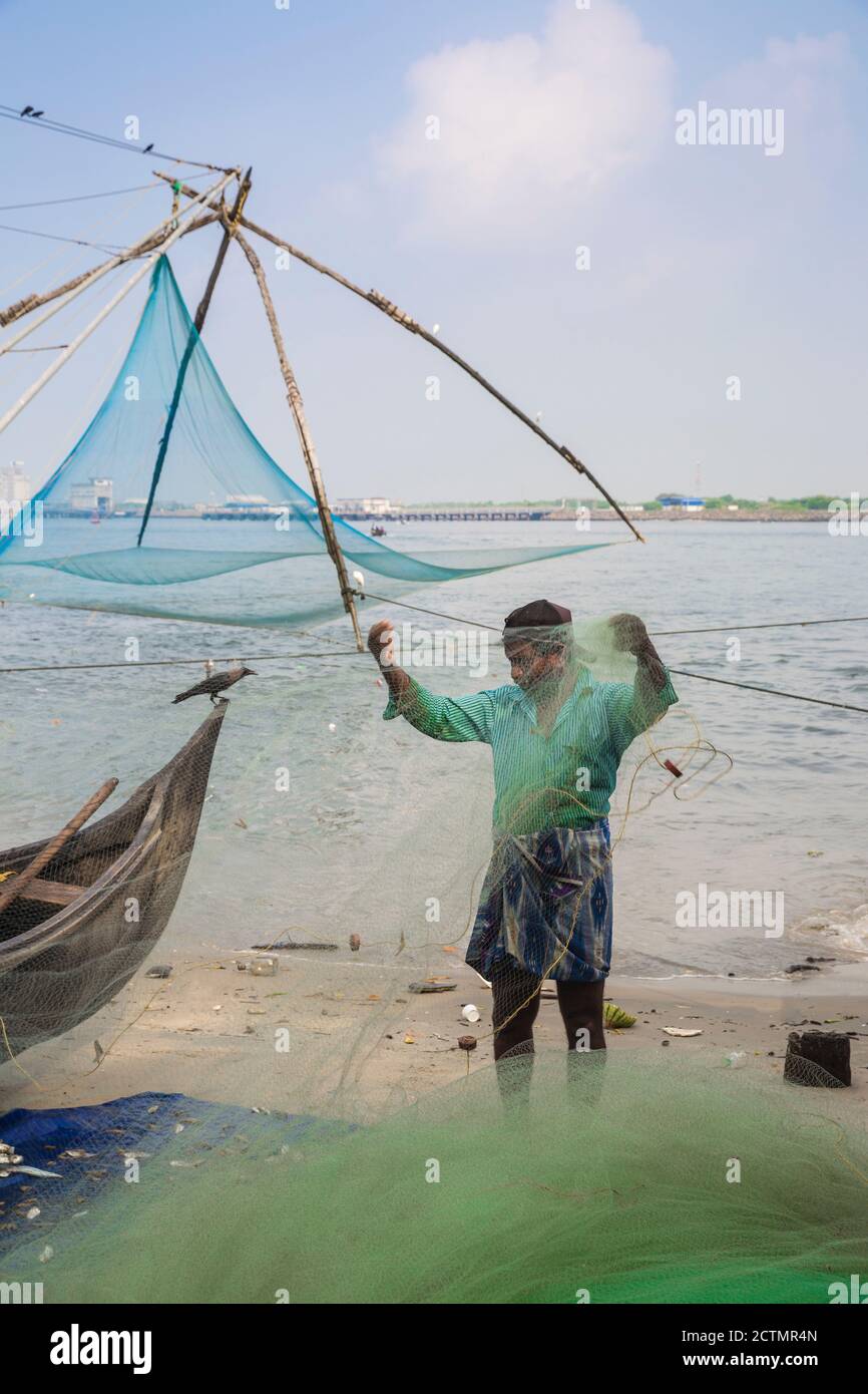 India, Kerala, Cochin - Kochi, Fort Kochi, Fisherman sorting fishing ...