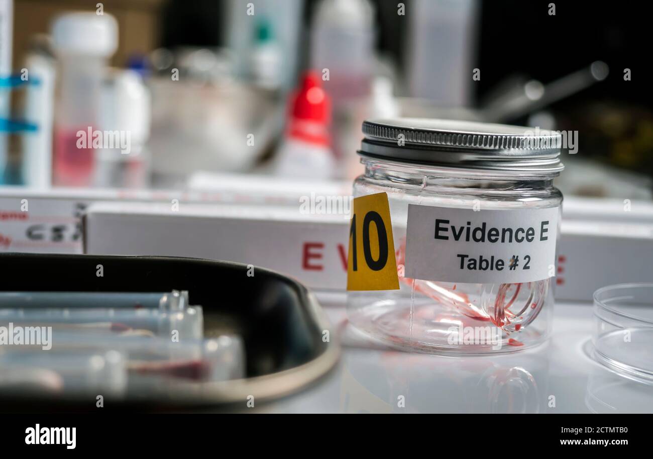 Blood-stained glass sample in an evidence jar, concept image Stock ...