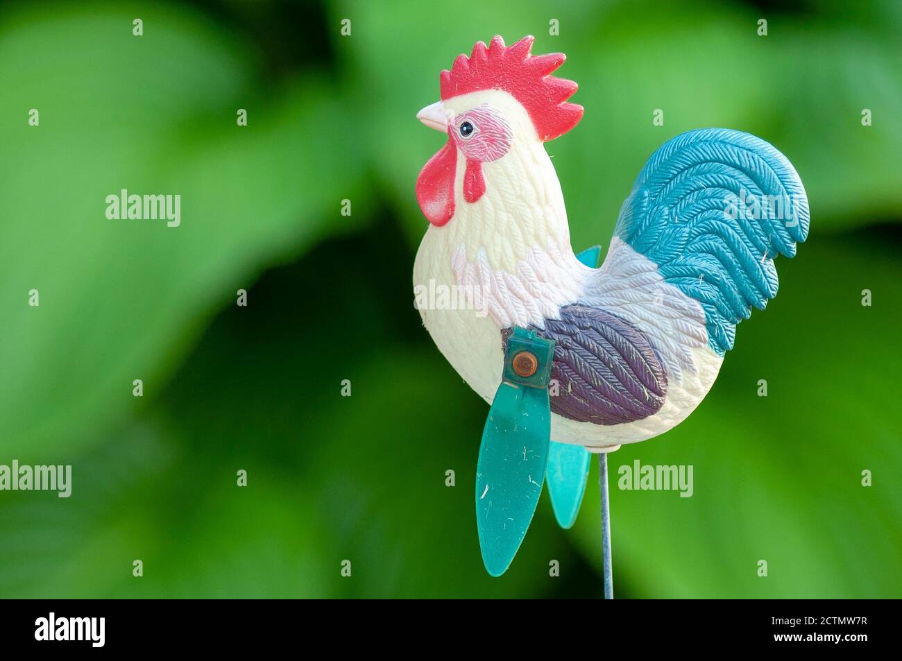 Garden decoration in the shape of a rooster Stock Photo - Alamy