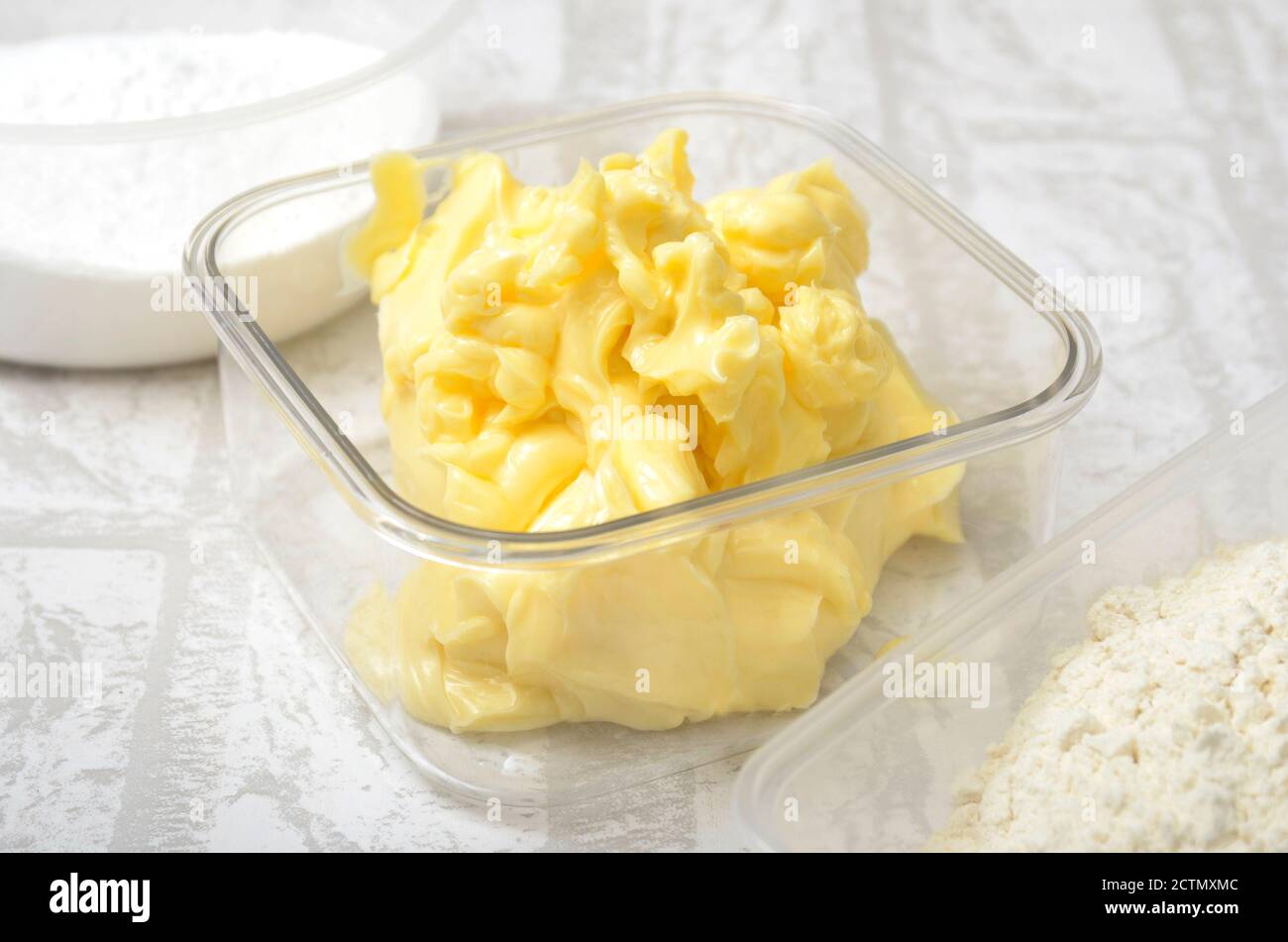 200 gram Butter in transparent plastic bowl. Butter for ingredient ...