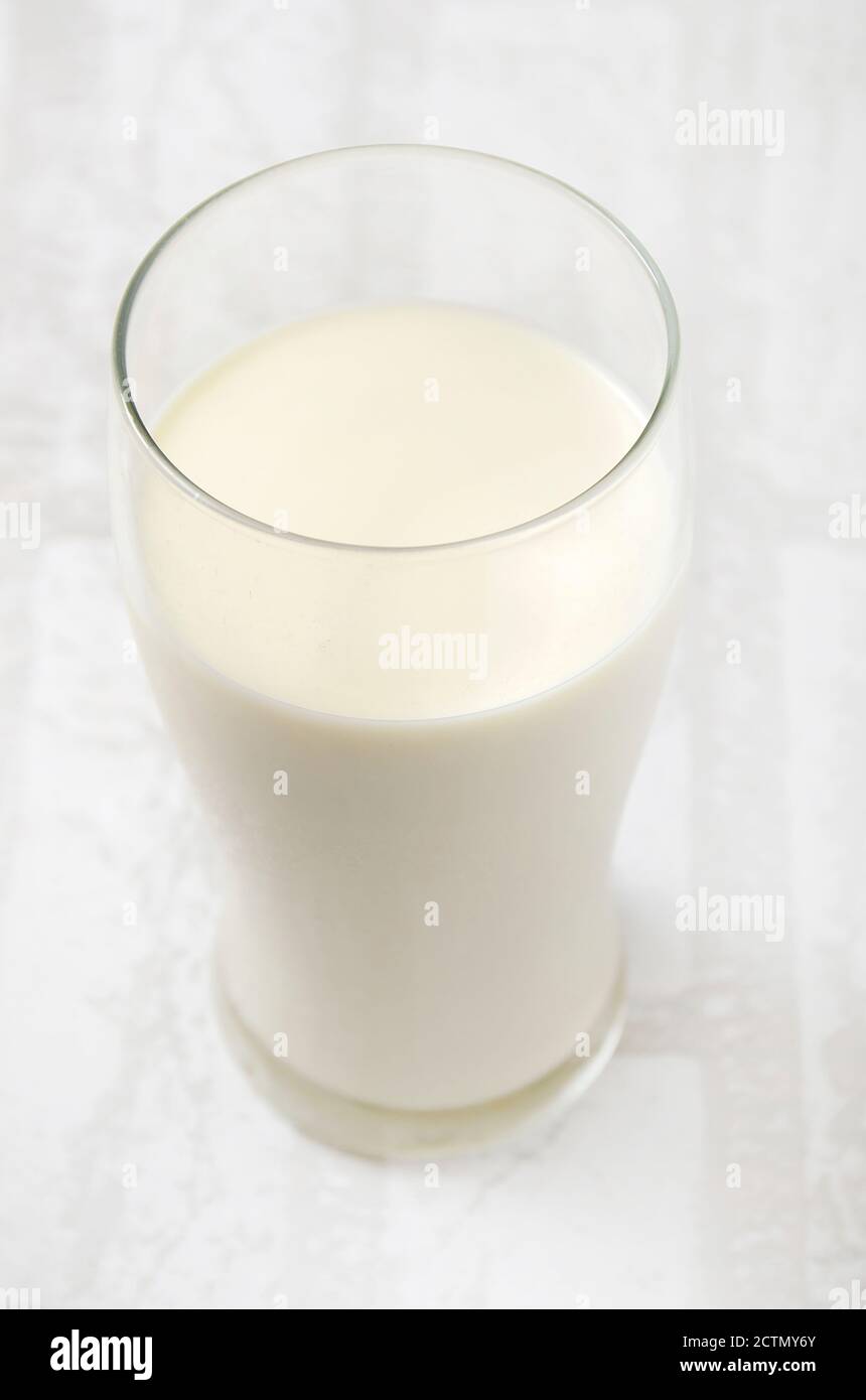 a glass of milk in white texture background Stock Photo - Alamy