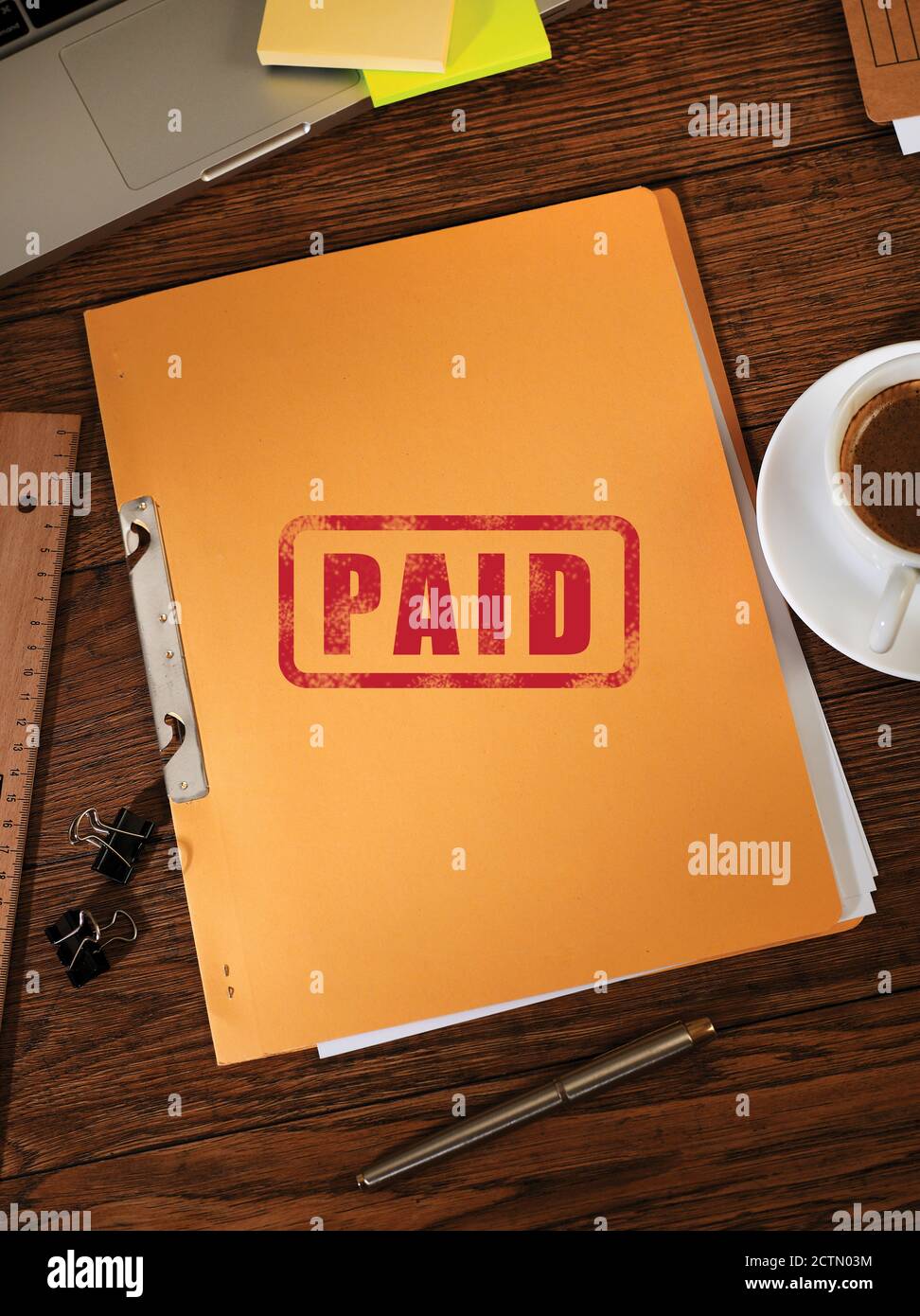Paid files and folders on desk Stock Photo - Alamy