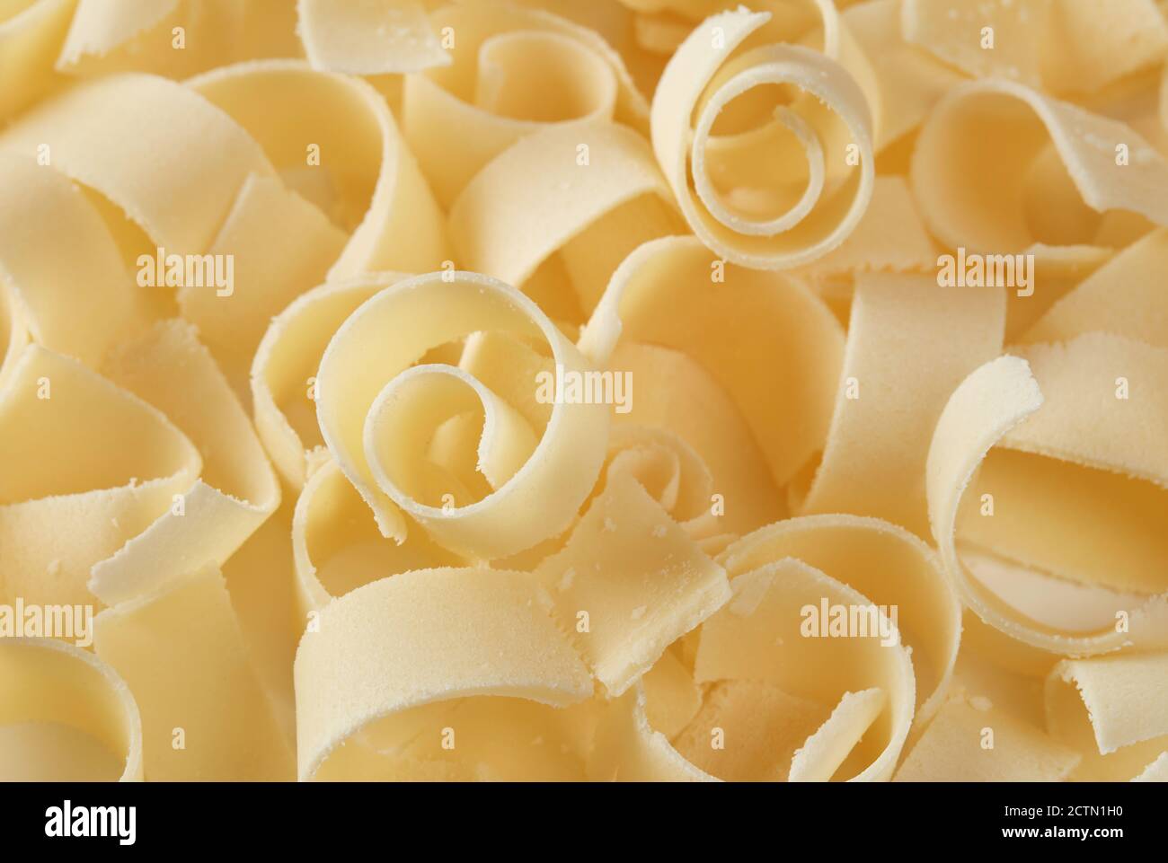 Parmesan cheese flakes background Stock Photo - Alamy