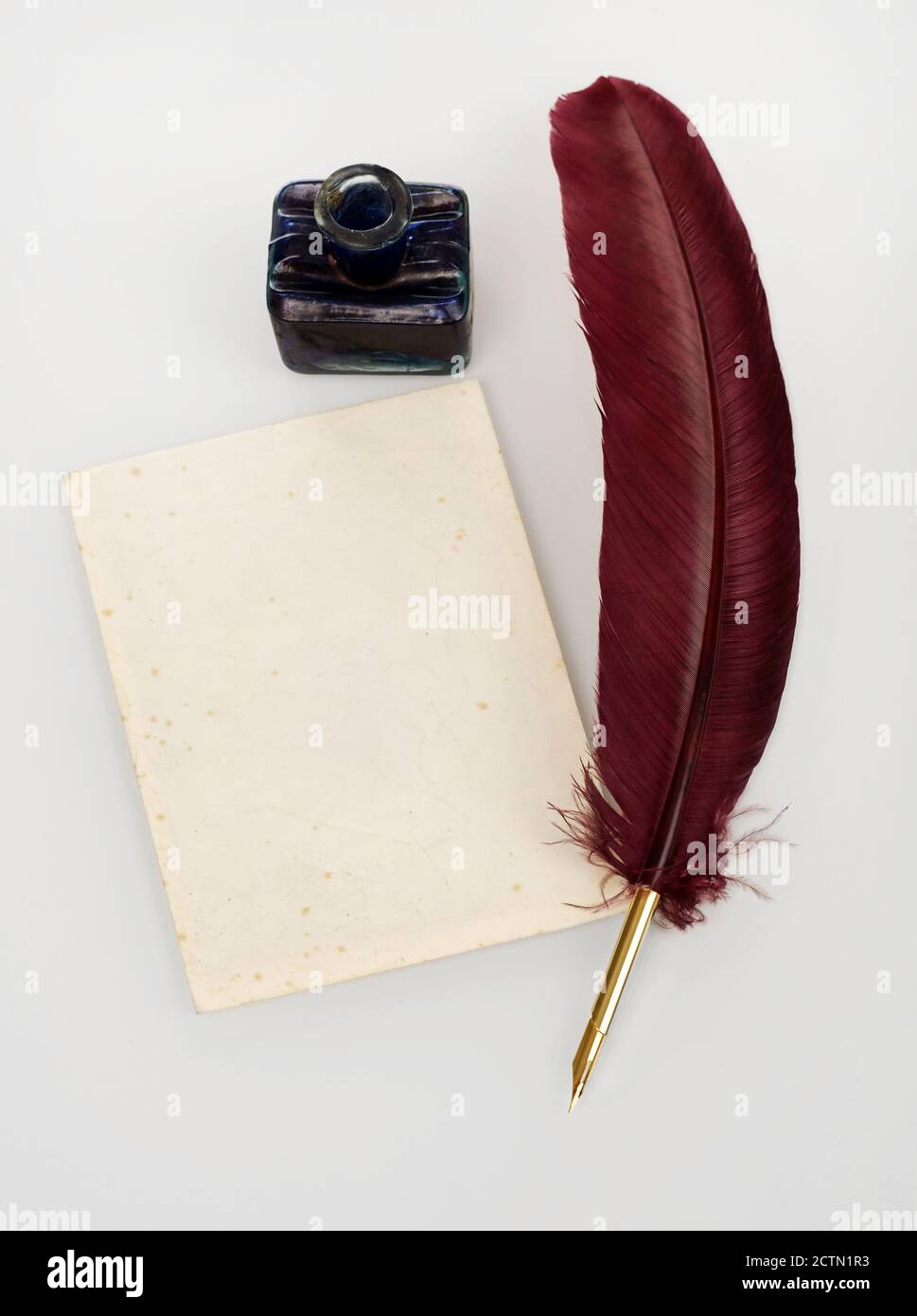 Quill, letter and ink well isolated on gray Stock Photo - Alamy