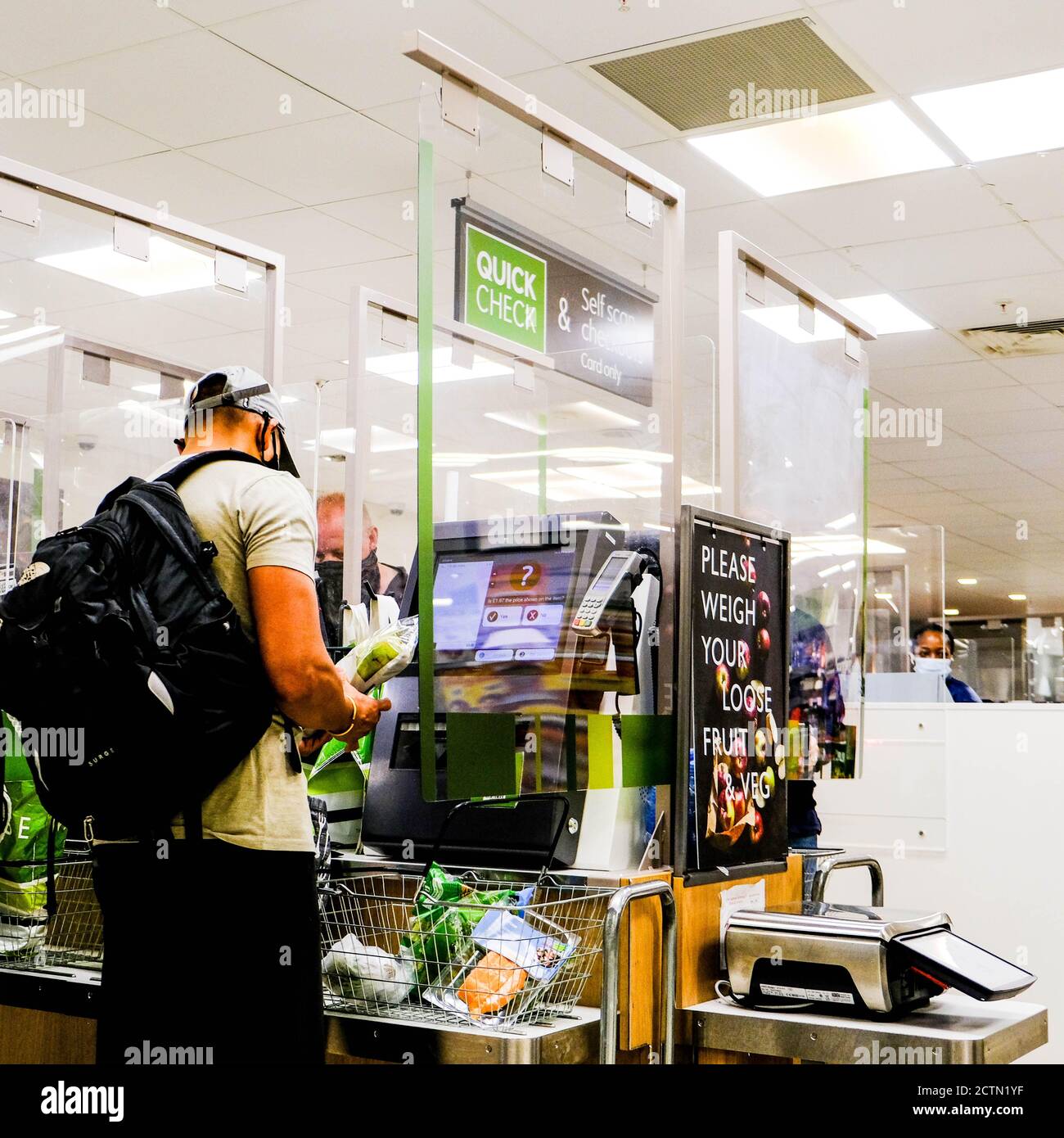 Male Shopper Paying For Shopping At A Self Service Till In John Lewis ...