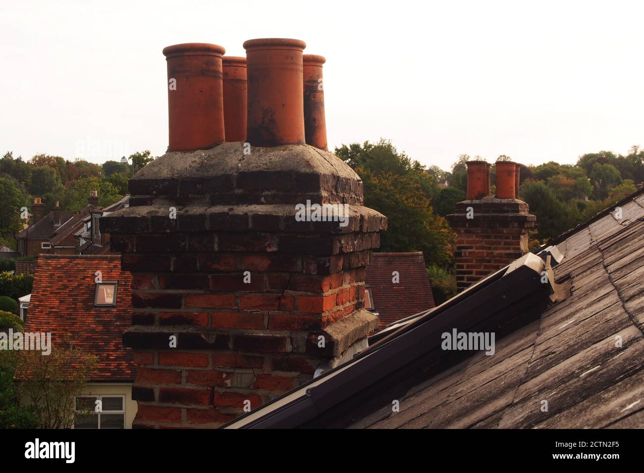 A view level with a traditional brick, four chimney pot stack house ...