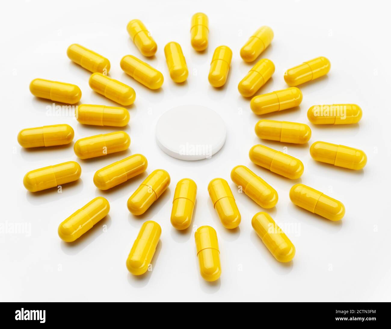 Yellow capsules on white background Stock Photo - Alamy