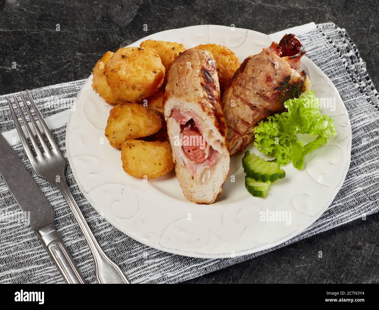 Pork rolls with baked poatatoes Stock Photo - Alamy