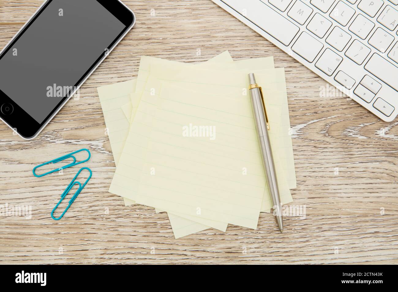 Blank adhesive note on office table Stock Photo - Alamy