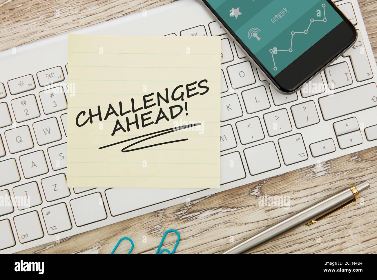 Challenges ahead message on adhesive note on office table Stock Photo ...